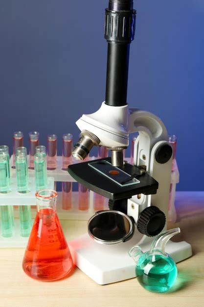 Premium Photo Microscope And Test Tubes On Table On Color Background