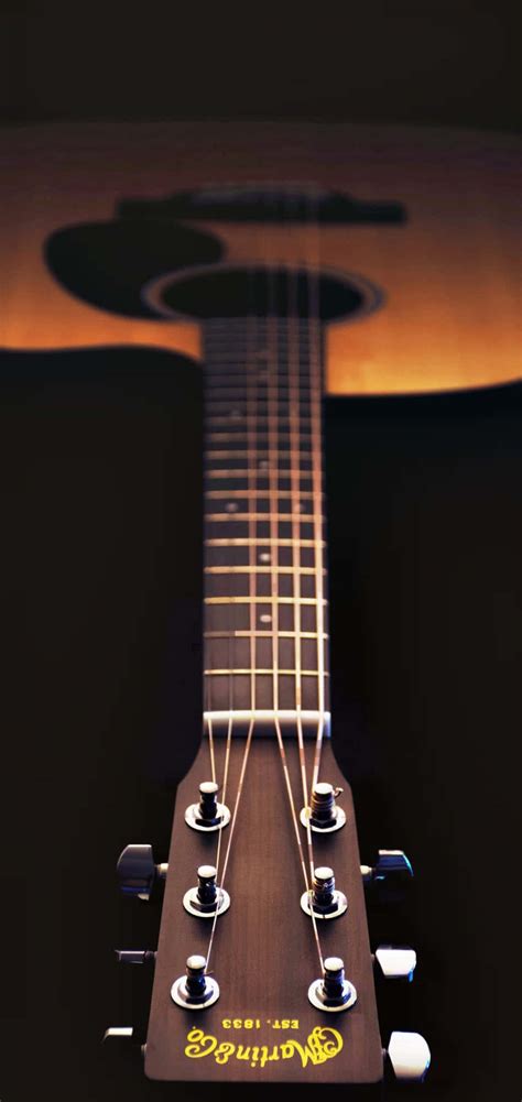 Download A Close Up Of An Acoustic Guitar Wallpaper