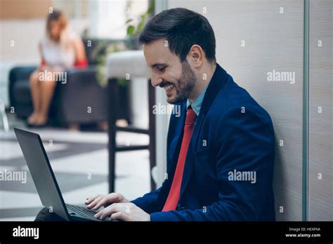 Laughing Businessmann Using Laptop In Office Stock Photo Alamy