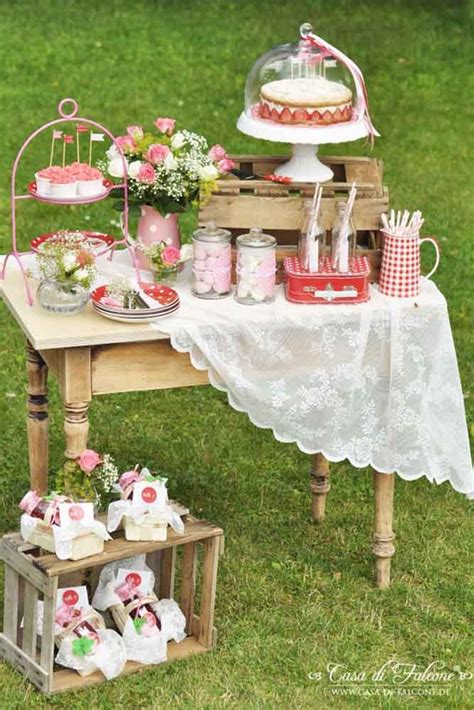A Table Topped With Cakes And Desserts On Top Of A Green Grass Covered