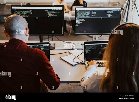 Male And Female Programmer Doing Coding Over Laptop In Startup Company