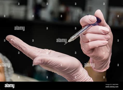 Contour Plastic A Cosmetologist Injects A Botulinum Toxin To Tighten