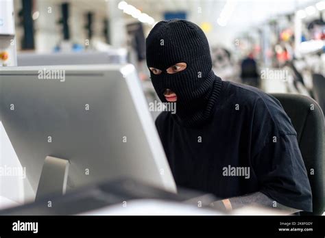 Computer Hacker Wearing Mask Using Desktop PC At Warehouse Stock Photo Alamy