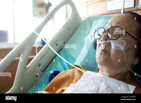 Sick Asian Elderly Woman Lying In Hospital Bed Undergoing Inpatient