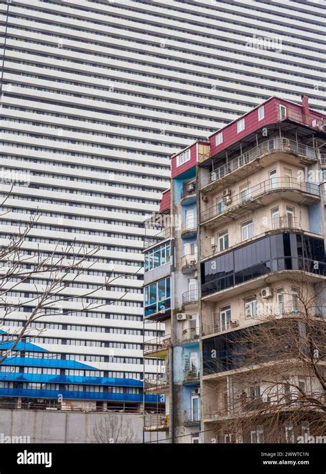 High Buildings Background Of Windows And Balconies Contrast Of A Poor