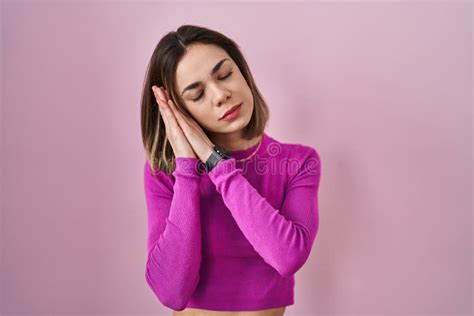 Hispanic Woman Standing Over Pink Background Sleeping Tired Dreaming