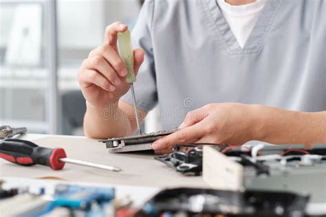 hands of female troubleshooting technician fixing tiny details of