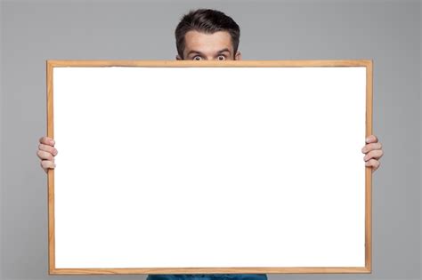 Free Photo Surprised Man Showing Empty White Board