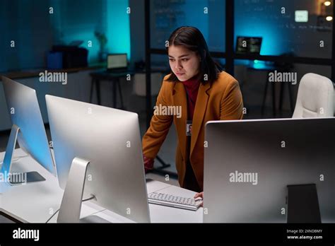 Portrait Of Female Cybersecurity Expert Using Computer With Multiple