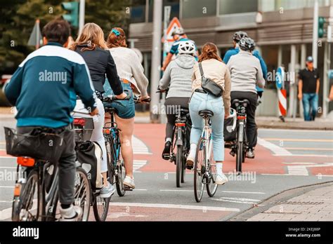 Many Cyclists Cross The Street And The Road At The Intersection At The