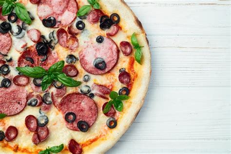 Pizza With Mozzarella Cheese Salami Sausages Olives And Basil