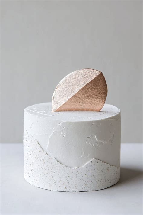 A Stunning Minimalist Cake Features Sharp Angular Fondant Textures And Is Adorned With Metallic