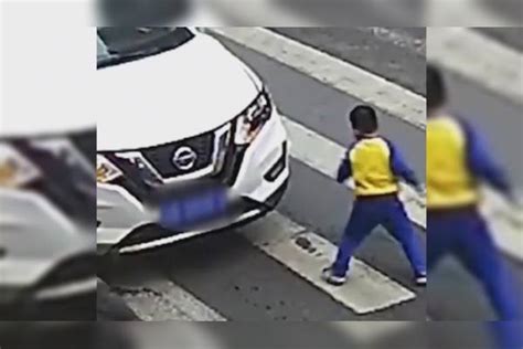 母子俩过马路被小车撞倒，小男孩爬起后搀扶妈妈，起身怒踹小轿车