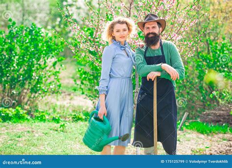 A Farmer And His Wife Standing In Their Field Crop Planting At Fields