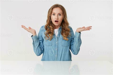 Portrait Of Young Wondered Cute Curly Blonde Lady In Denim Shirts