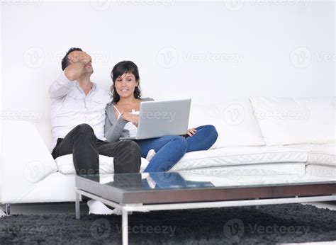 Joyful Couple Relax And Work On Laptop Computer At Modern Home 10953223