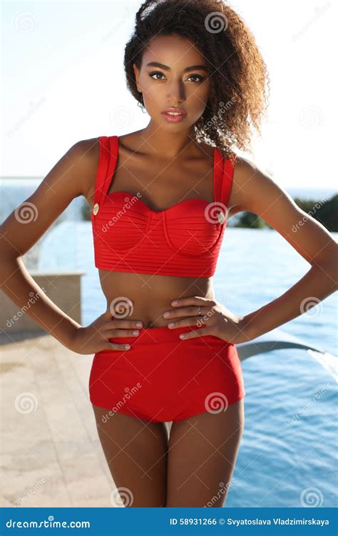 Beautiful Sensual Girl With Dark Hair Wears Luxurious Red Swimsuit