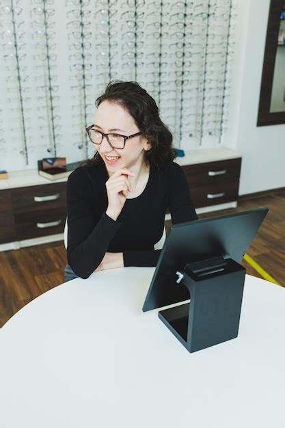 Premium Photo Optics Shop A Young Woman Chooses Glasses In An Optical