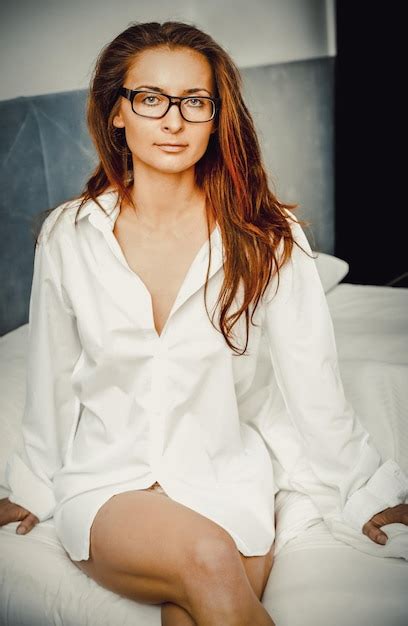 Premium Photo Smiling Young Woman Sitting On Bed