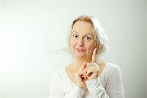 Portrait Of Serious Stylish Girl Raises Finger Up Says Attention