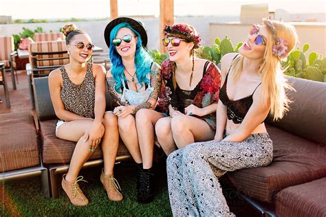 A Group Of Girl Friends Hanging Out Outdoors In The Sunlight By