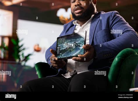 African American Government Spy Monitoring Satellite Footage To Gather Data Reviewing Important