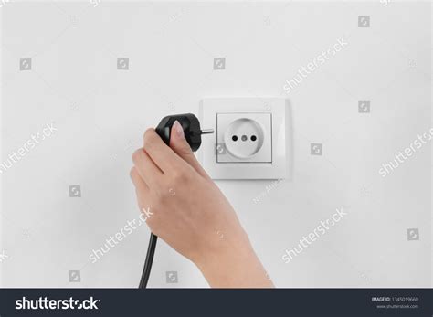 Woman Putting Plug Into Power Socket Stock Photo Shutterstock