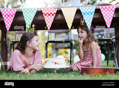 Cute Girls With Paper Crowns Eating Birthday Cake Under Table Birthday