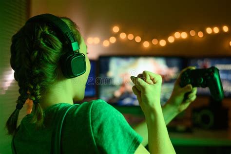 The Girl Emotionally Plays Video Games With A Headset And A Joystick