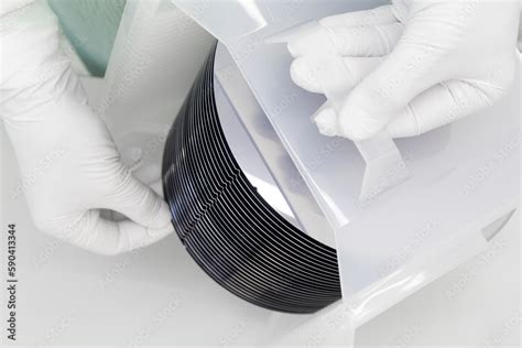 Gloved Hand Holding A Silicon Wafer In Plastic Holder Box Used In Electronics For The