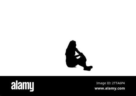 Drunk Woman Sits On The Floor And Drinks Alcohol From A Bottle Stock