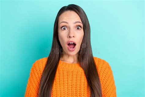 Photo Of Impressed Young Brunette Lady Look Camera Wear Orange Pullover