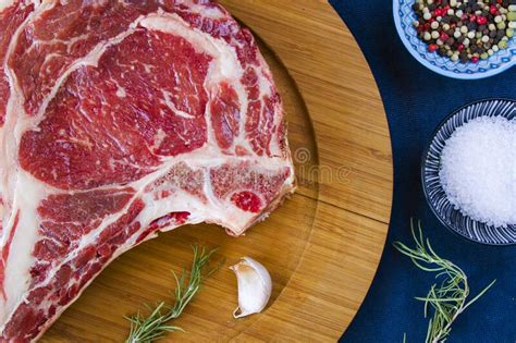 Raw Beef Meat On The Table Spices And Rosemary Rib Eye Steak