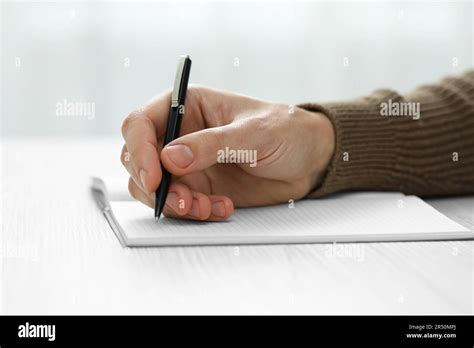 Man Writing In Notebook At White Wooden Table Closeup Stock Photo Alamy