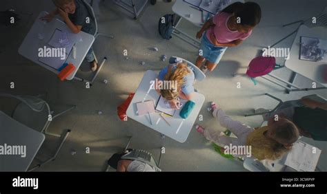 Classmates Bullying Sad Elementary School Girl Sitting At Desk And Crying They Laughing And