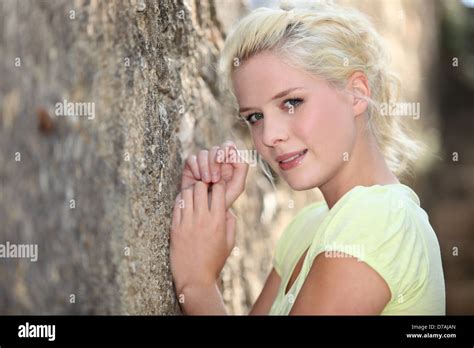 Woman Leaning Against Wall Stock Photo Alamy