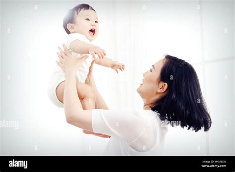 Mother Lifting Her Baby Stock Photo Alamy