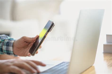 Man Hands Holding Smartphone With Laptop Keyboard Young Man Freelance Hands Typing On Laptop