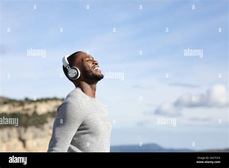 Happy Man Breathing Listening To Music Outdoors Stock Photo Alamy