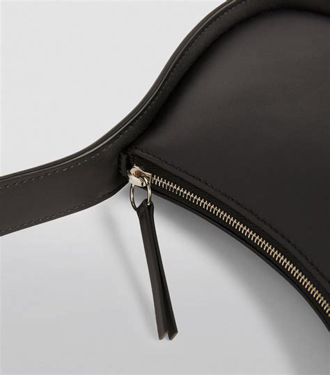 The Row Black Leather Half Moon Shoulder Bag Harrods Uk
