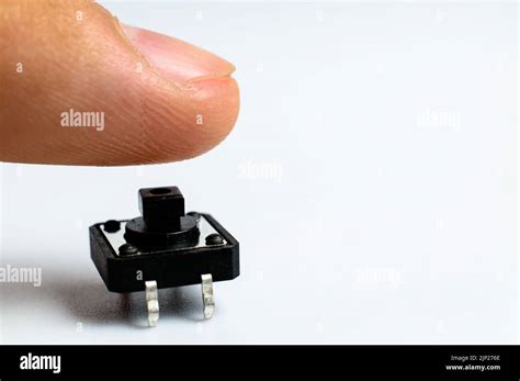 finger is pressing small black button starting impulse white