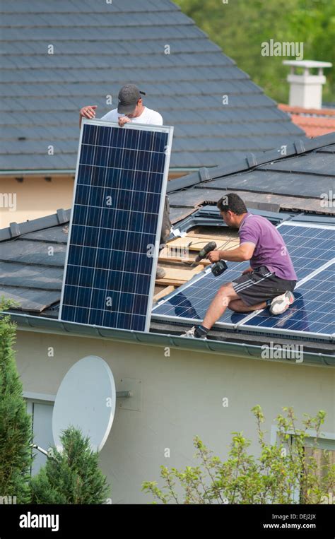 Installation Of Photovoltaic Solar Panels On Roof Of House Germany