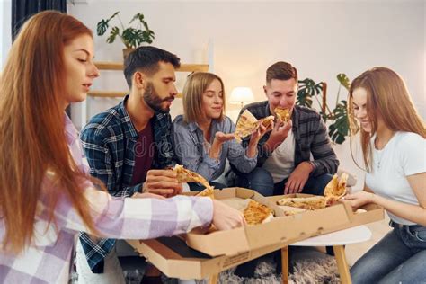 With Delicious Pizza Group Of Friends Have Party Indoors Together Stock Photo Image Of