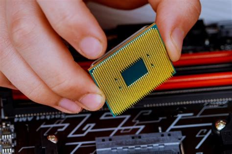 Premium Photo The Technician Is Putting The Cpu On The Socket Of The