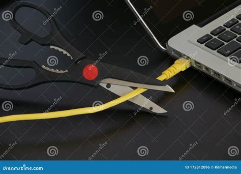 Cutting An Ethernet Cord Connected To A Laptop Computer With Scissors Stock Photo Image Of