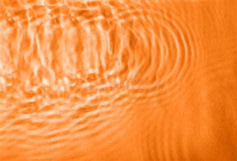 concentric waves on water surface after falling drops top view toned