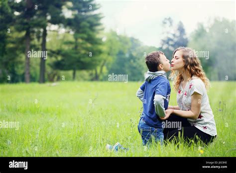 Mom Kissing Son Stock Photo Alamy