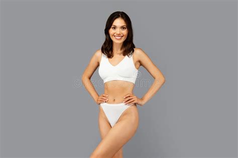 Positive Caucasian Slim Young Woman In White Underwear Show Perfect