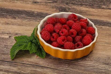 Premium Photo Red Bright Ripe Sweet Raspberry With Leaf