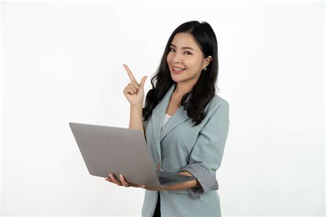 Happy Asian Business Woman Holding Laptop Computer And Looking At The